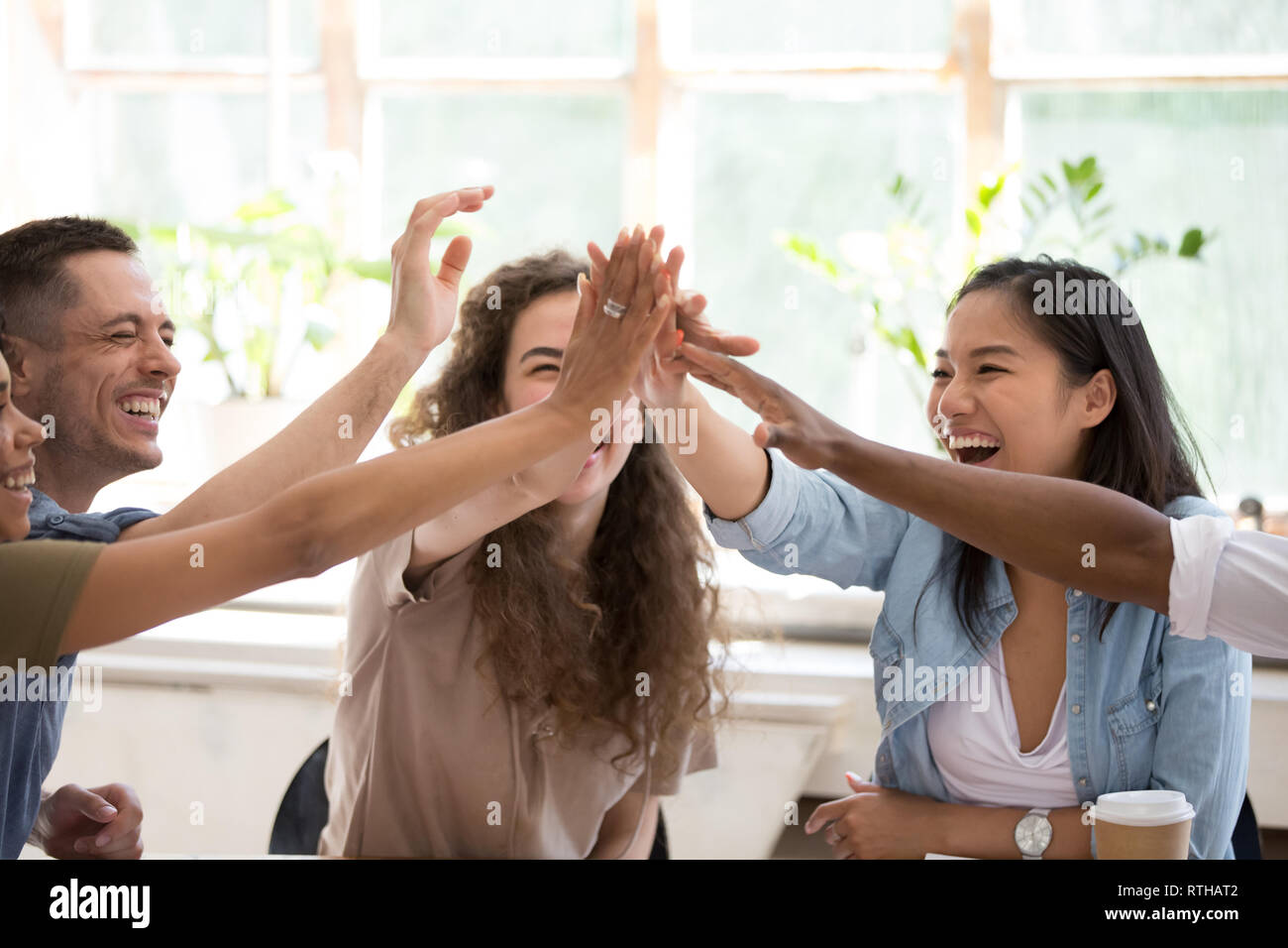 Happy african asian caucasian business people team give high five Stock ...
