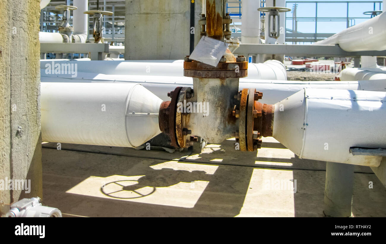 Manual shut-off valve on the pipeline. Refinery equipment Stock Photo ...