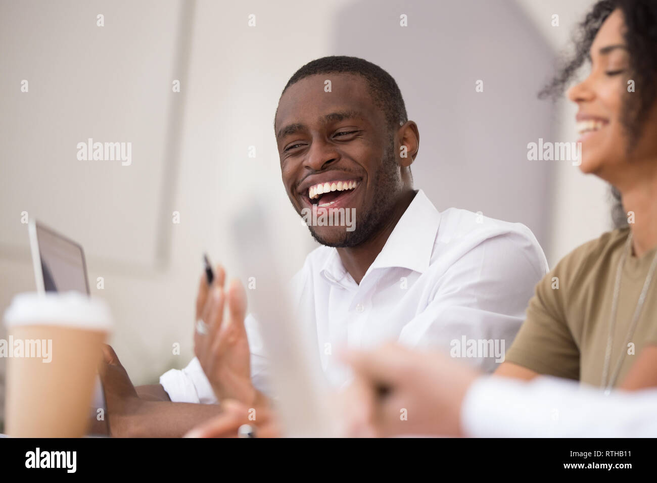 Happy african businessman laughing talking working together with ...