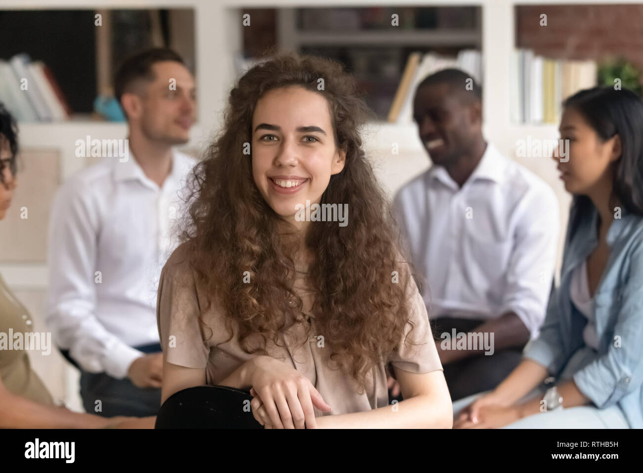 Young female therapist training participant coach posing at group ...