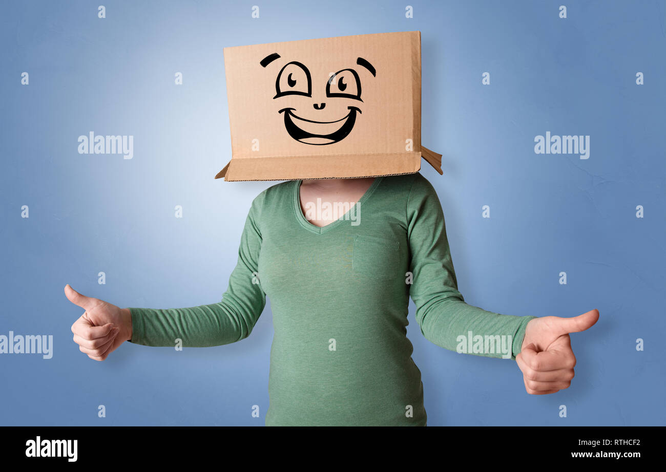 Young woman with happy face illustrated cardboard box on her head Stock ...