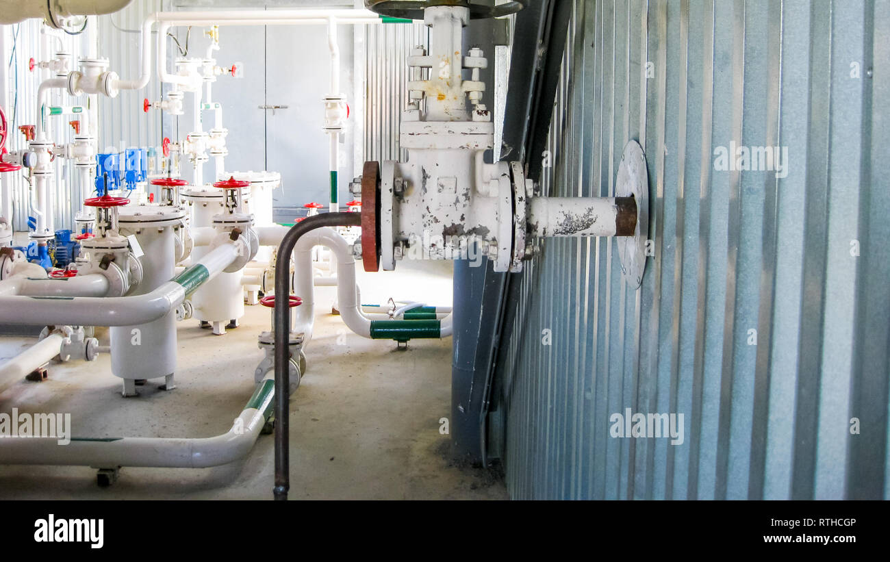 Pumping water pumping. Hand valve on the pipe. Oil refinery. Equipment for primary oil refining ...