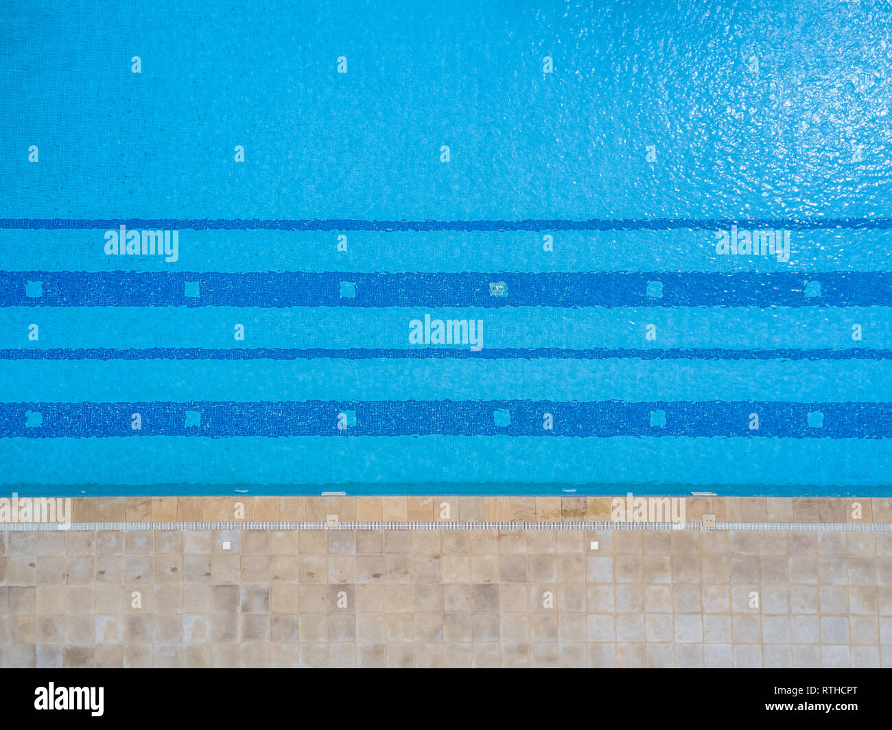 Aerial view of drone, transparent water pool and blue background with ...
