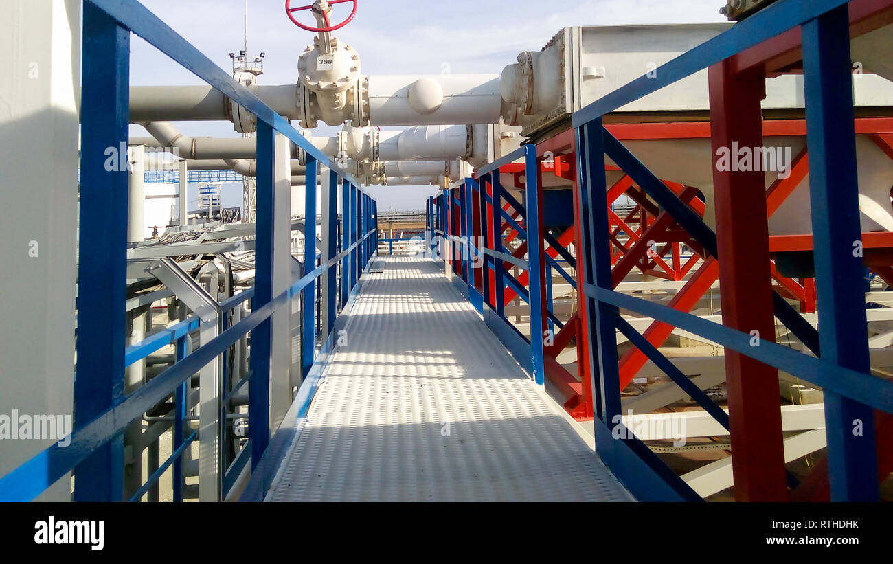 Steel service platform and stairs. Equipment refinery Stock Photo - Alamy