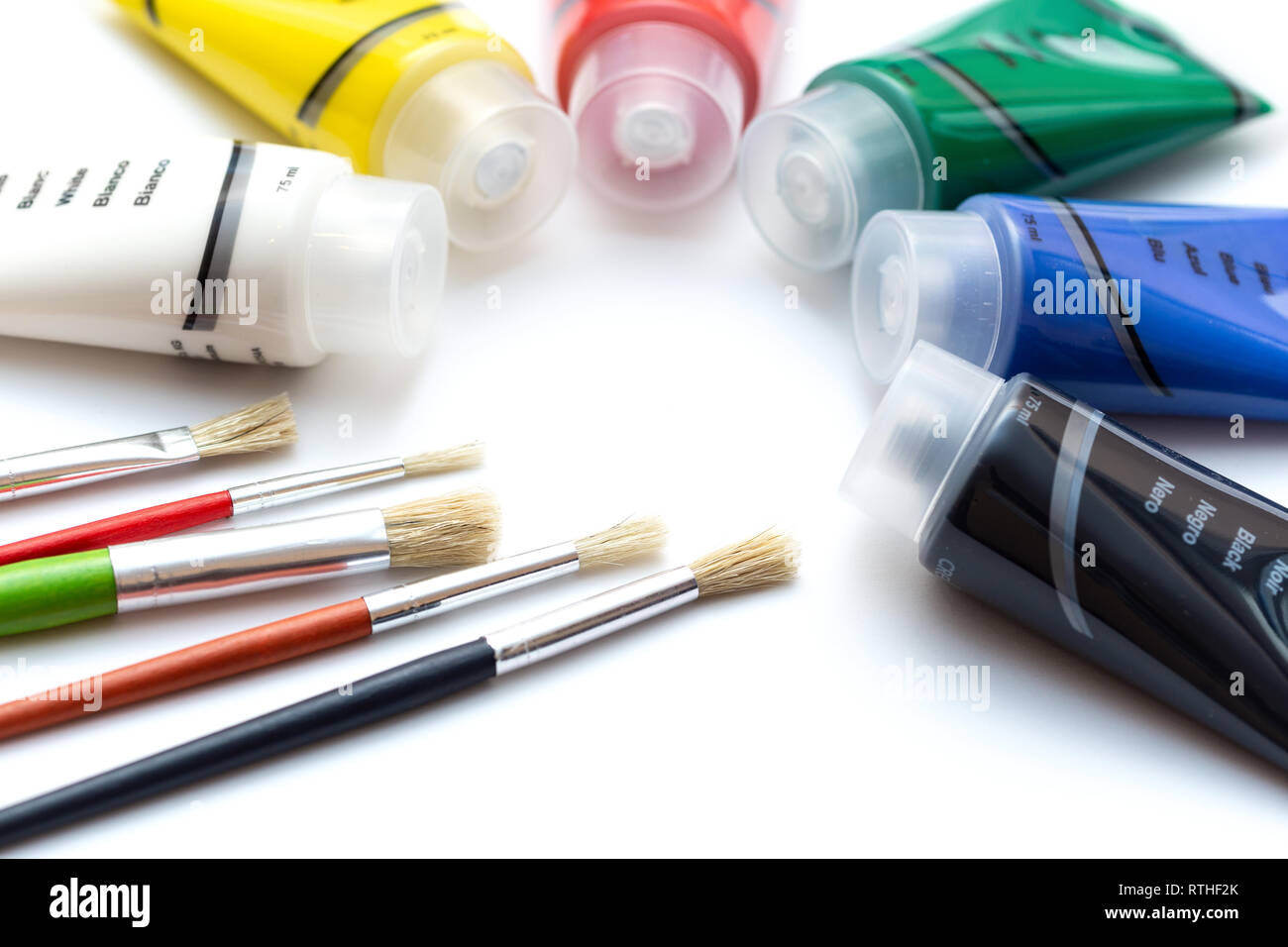 Acrylic color tubes and brushes. Tube of several acrylic colors with ...