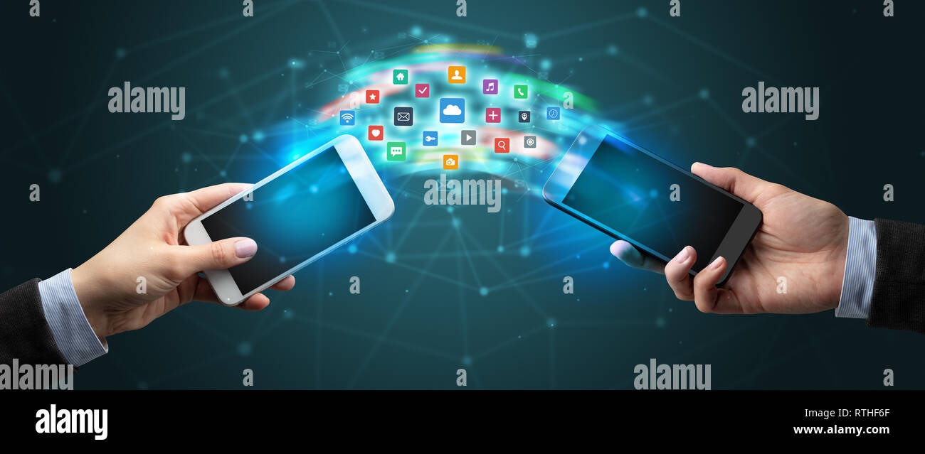 Two mobile phones syncing applications concept Stock Photo - Alamy