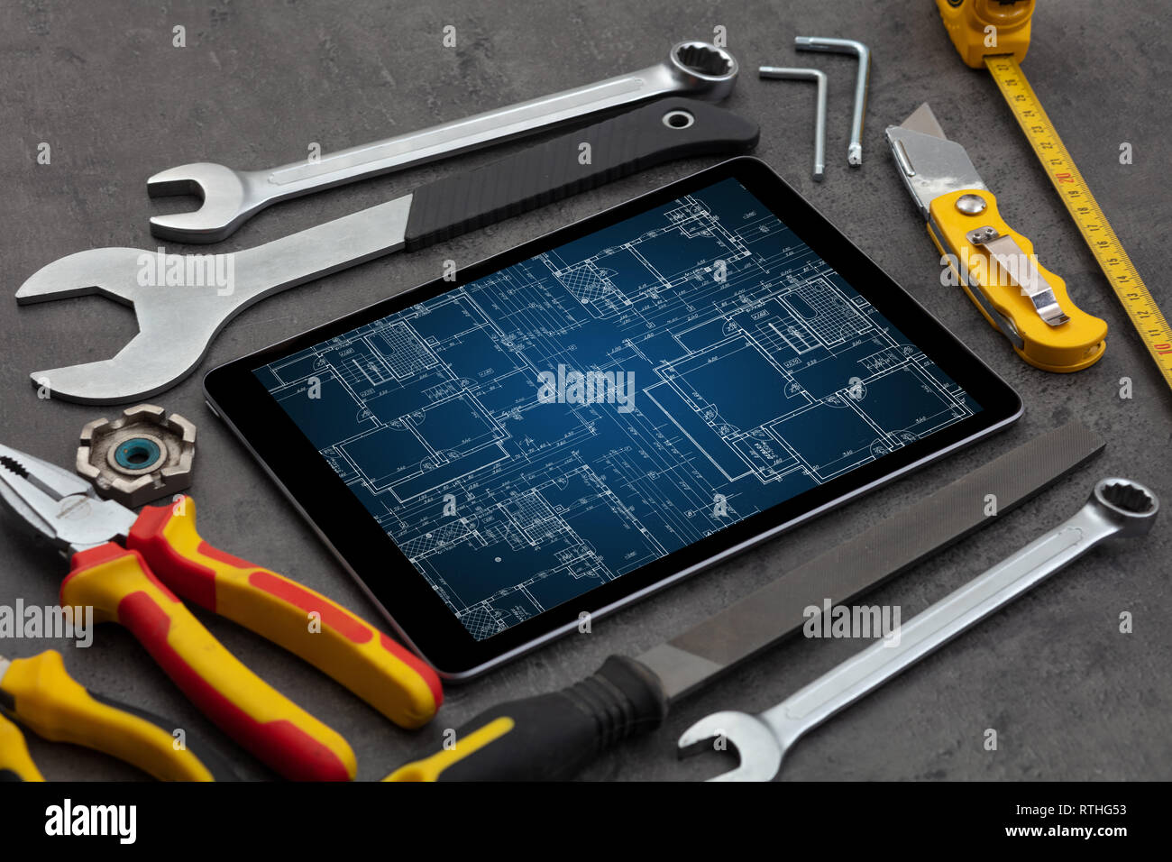 Tablet with construction tools and blueprint concept Stock Photo - Alamy