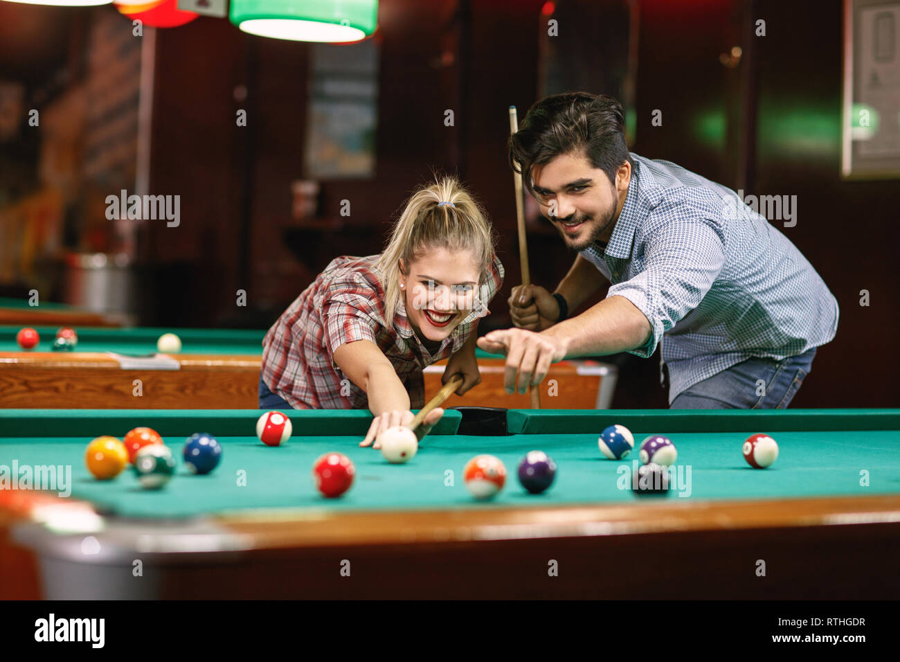 billiard- smiling couple shooting pool ball in bar Stock Photo - Alamy