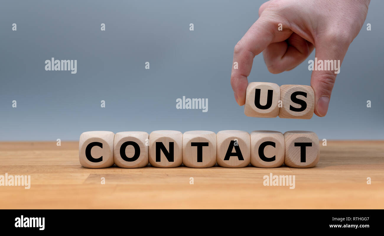 Dice form the word "CONTACT US" while a hand rises the letters "US ...