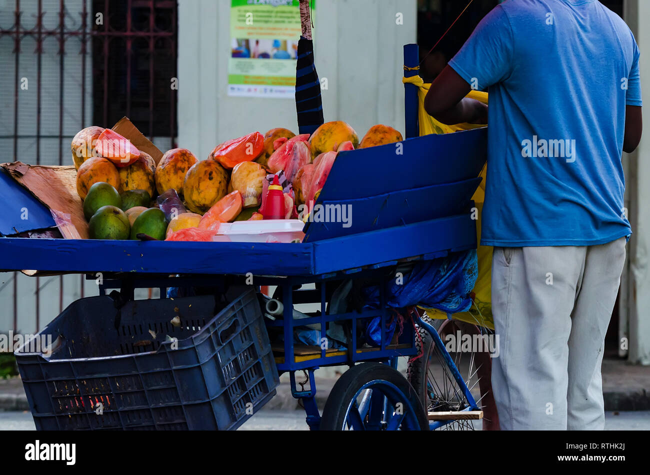 View of tropical fruit seller with cart on street in Dominican Republic ...