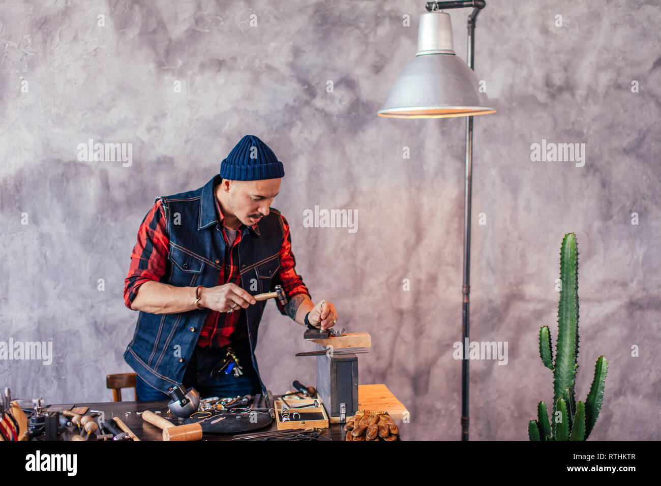 tedious and detailed work. man creating adornments fo people. close up ...