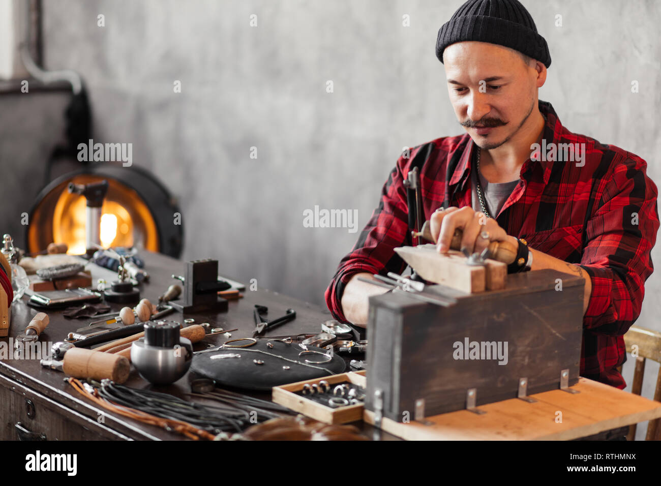 young jeweler sawing the chair for a client. close up photo.copy space ...