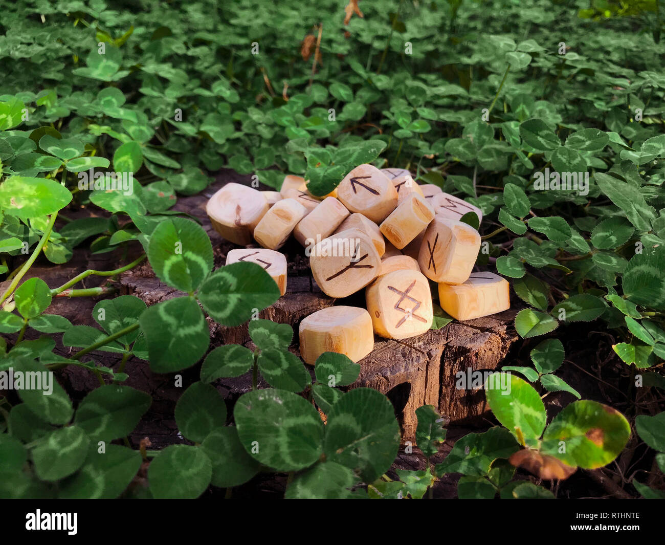 A stack of wooden runes at forest. Wooden runes lie on a rock ...