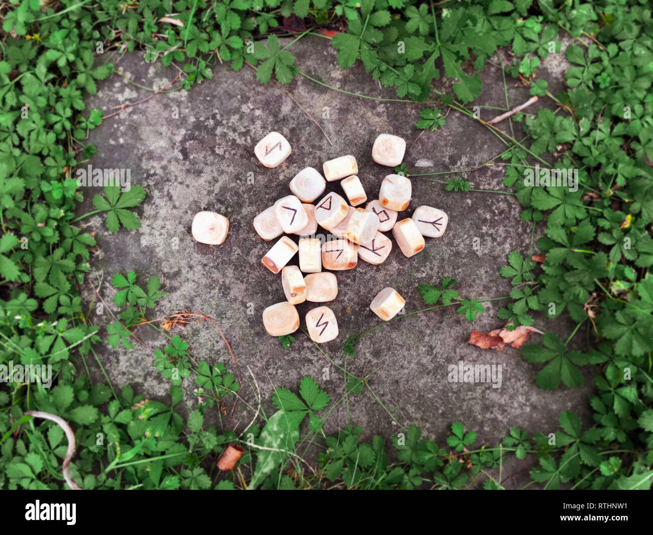 A stack of wooden runes at forest. Wooden runes lie on a rock ...