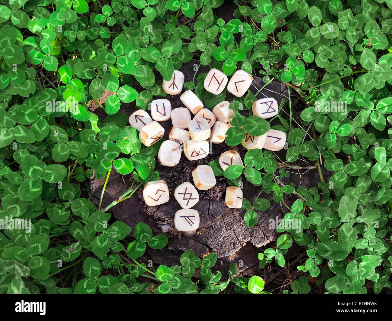 A stack of wooden runes at forest. Wooden runes lie on a rock ...