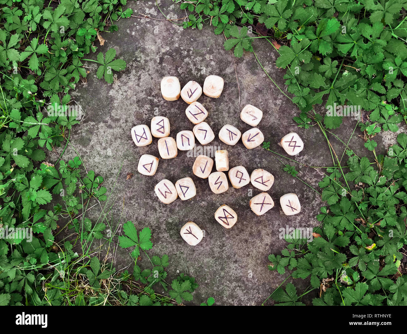 A stack of wooden runes at forest. Wooden runes lie on a rock ...