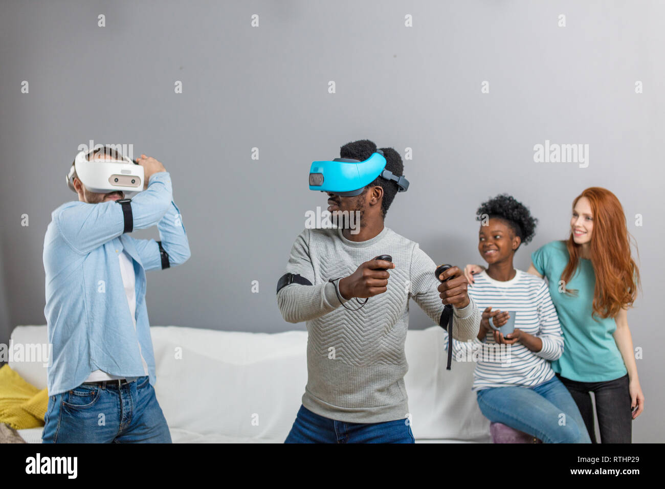 Multiethnic diverse friends enjoying VR technology, two guys wearing vr ...