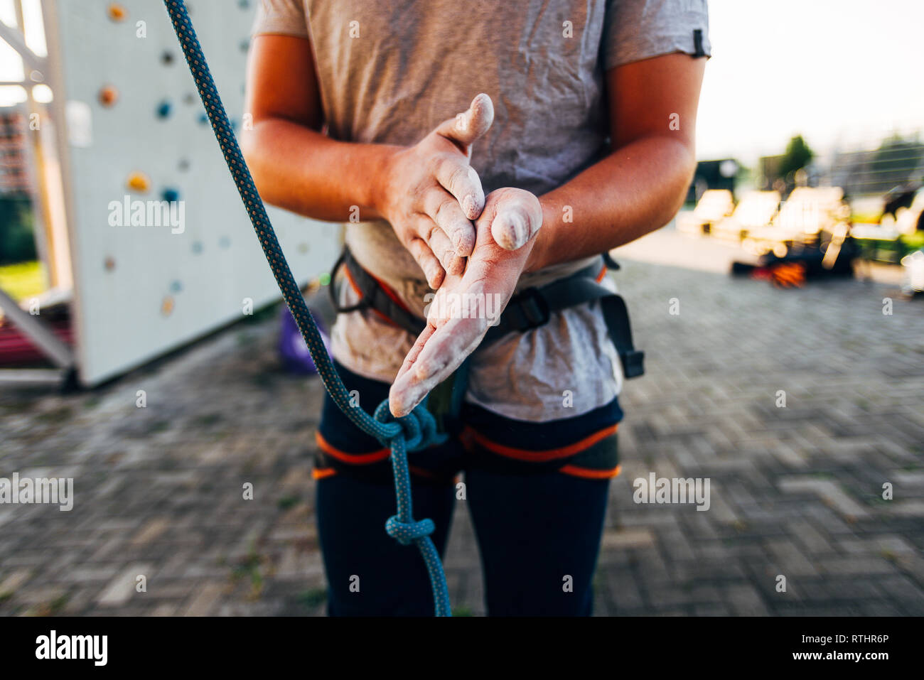Climber man coating his hands in powder chalk magnesium and preparing ...
