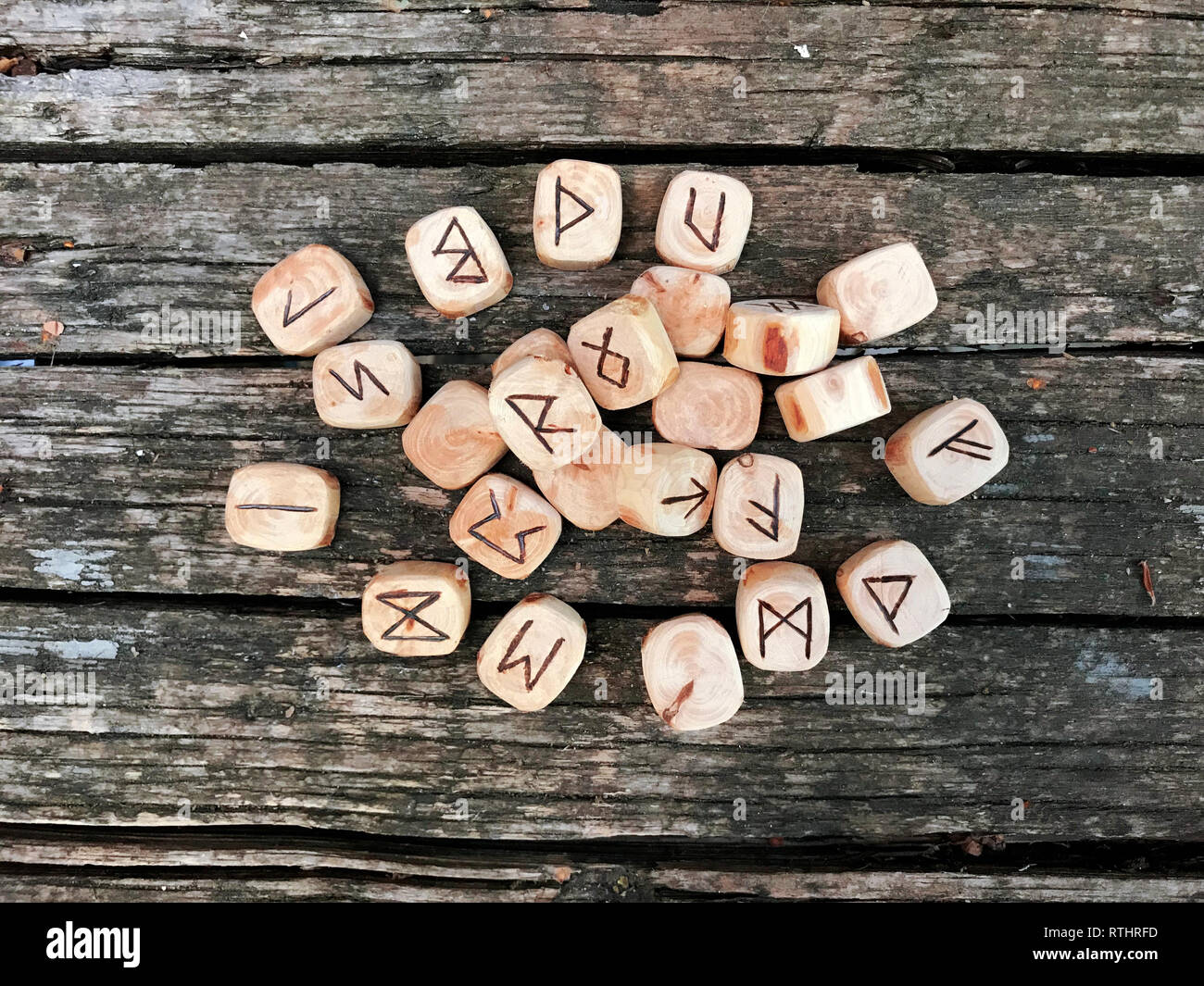 A stack of wooden runes at forest. Wooden runes lie on a old wood ...