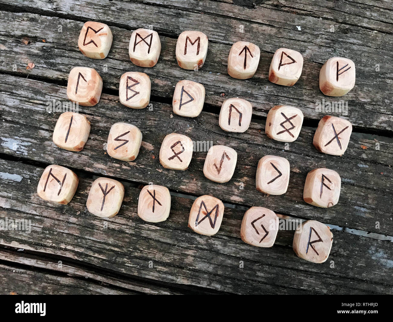 A stack of wooden runes at forest. Wooden runes lie on a old wood ...
