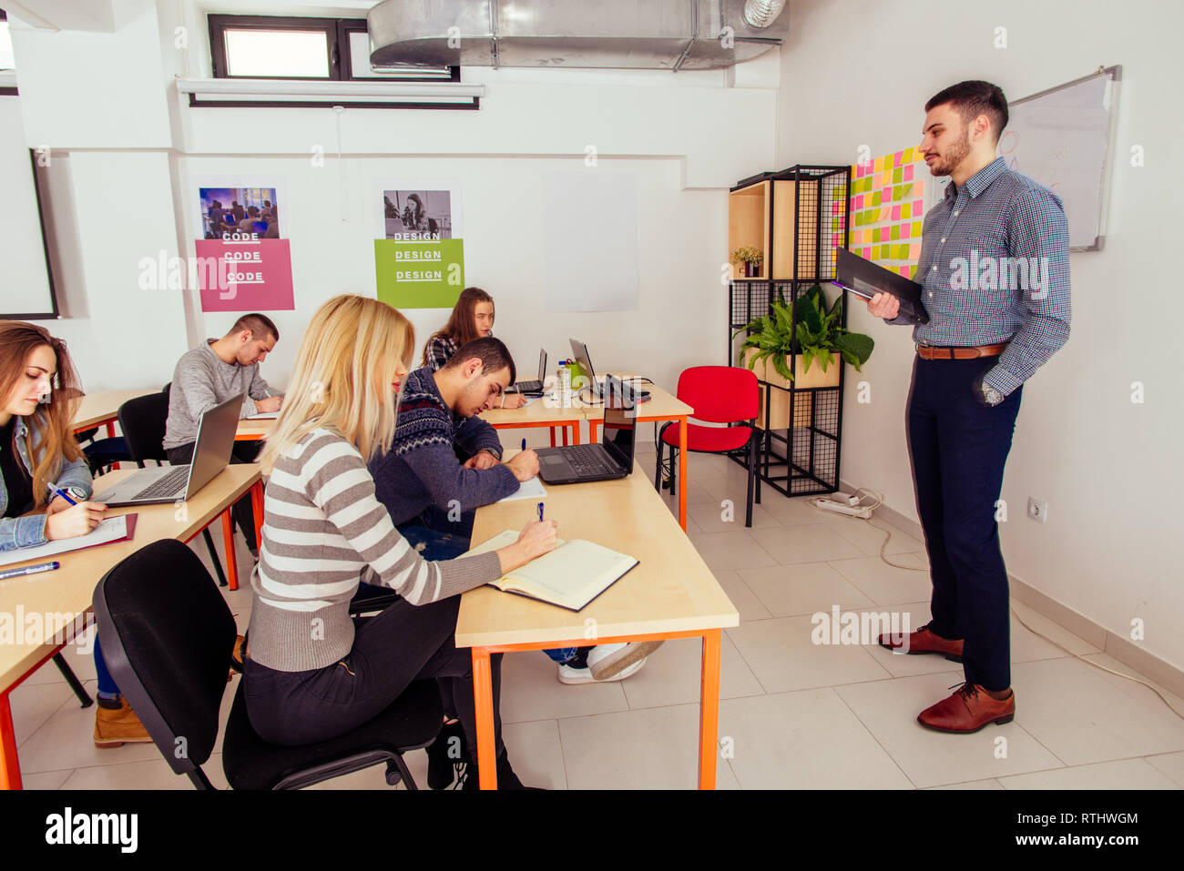 Young students are listening carefully their professor Stock Photo - Alamy