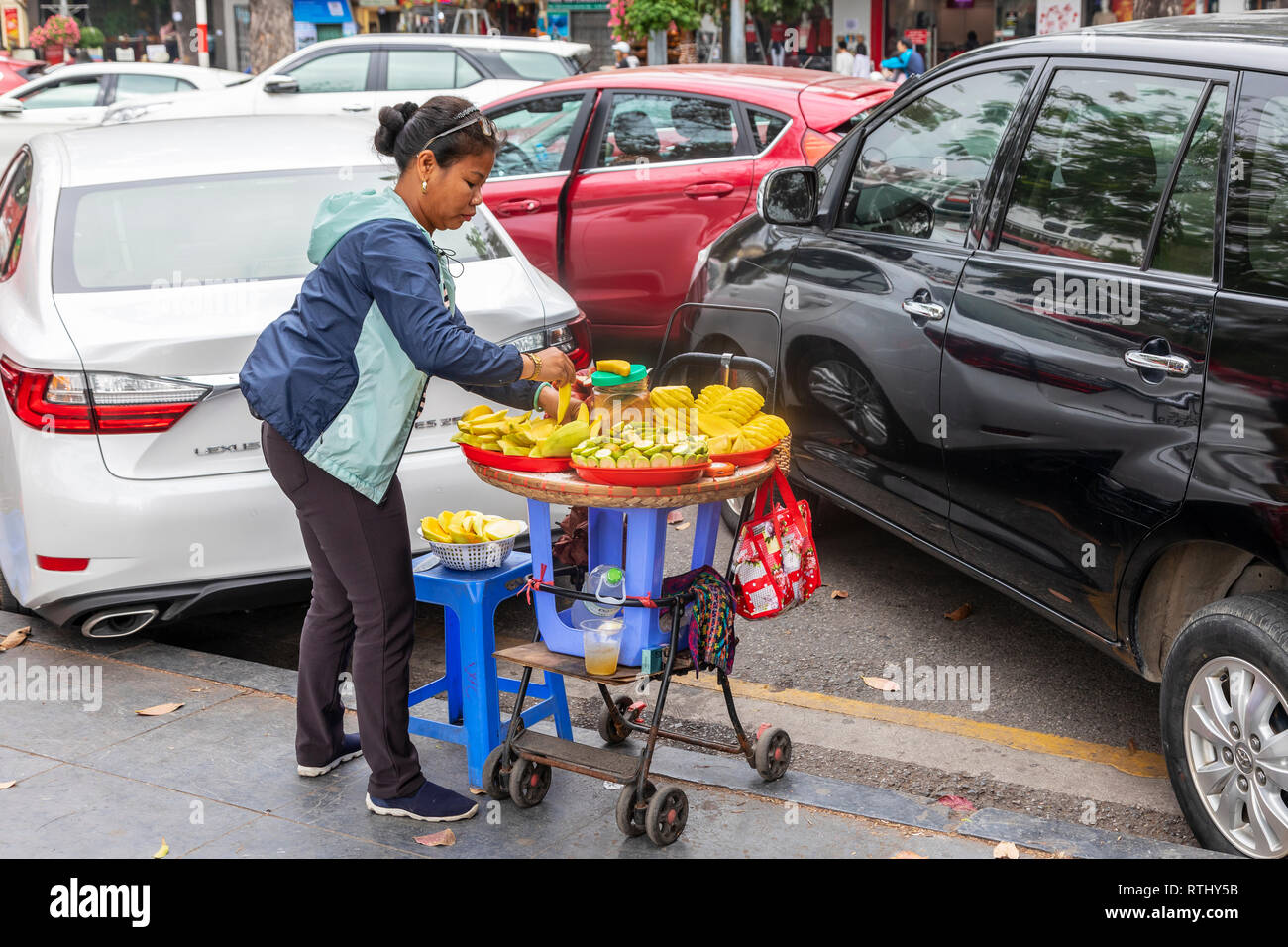 Woman selling fresh fruit from a makeshift stall on the street in the ...