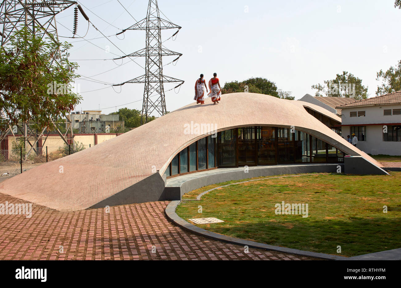 Teachers walk hand in hand on roof. Maya Somaiya Library, Kopargaon ...