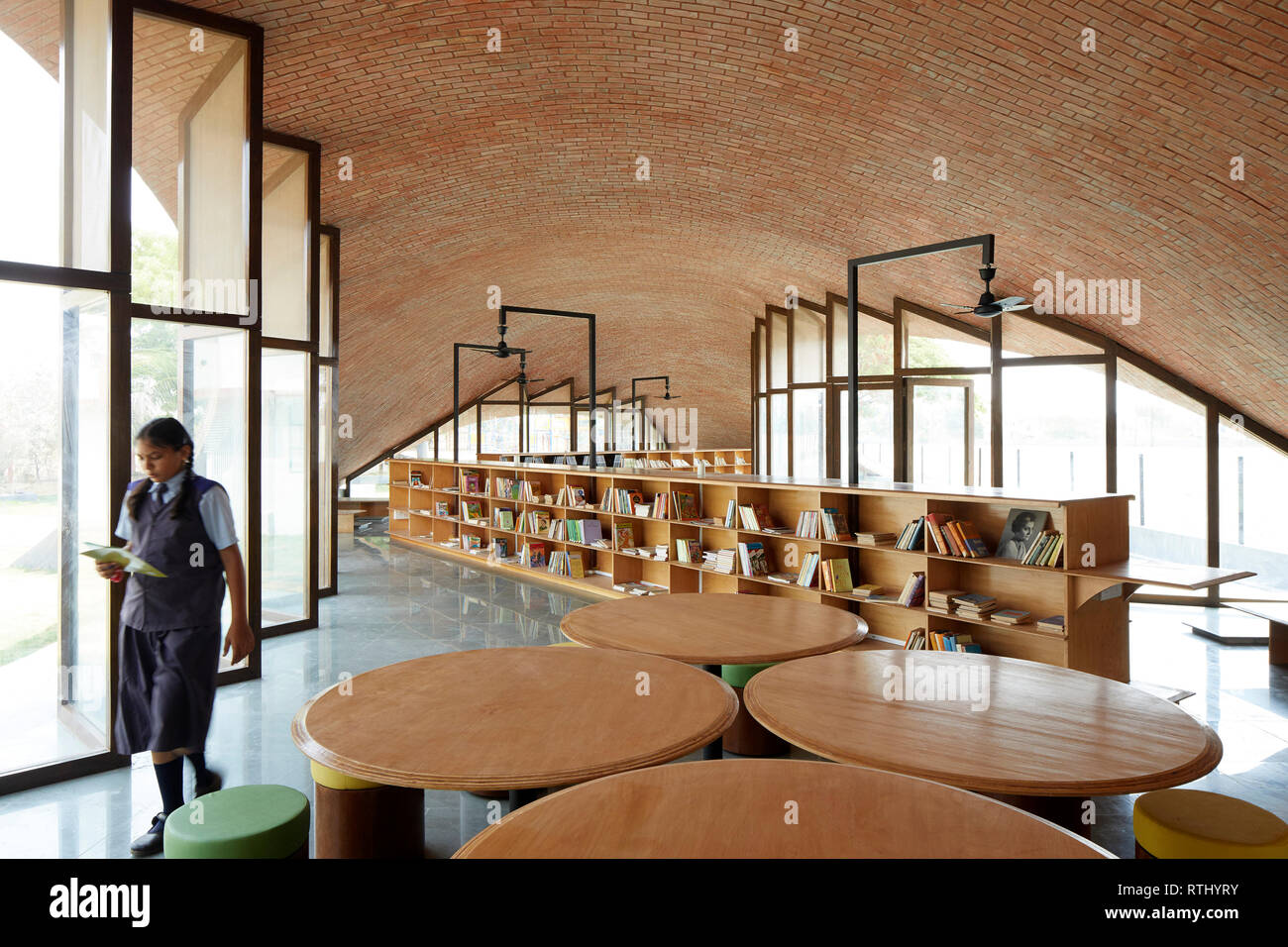 Interior view with passing student. Maya Somaiya Library, Kopargaon ...