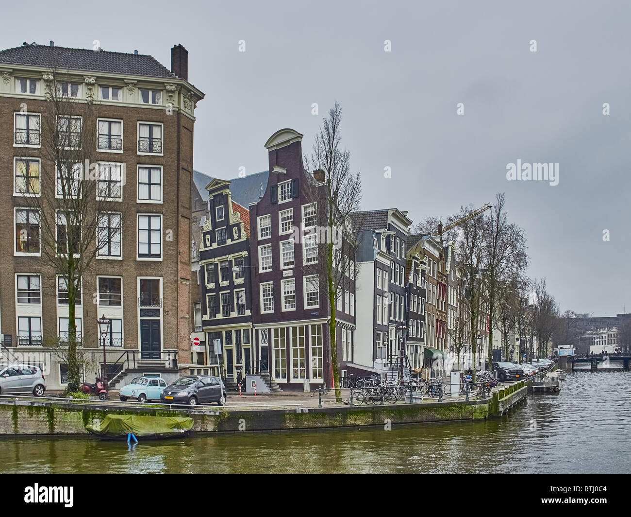 Amsterdam cityscape in January with canals and leaning old houses with ...