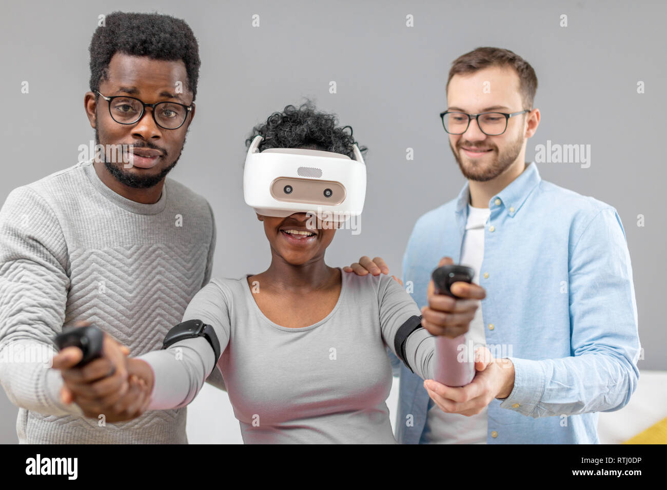 Happy African girl learning to use virtual reality gadget before buying ...