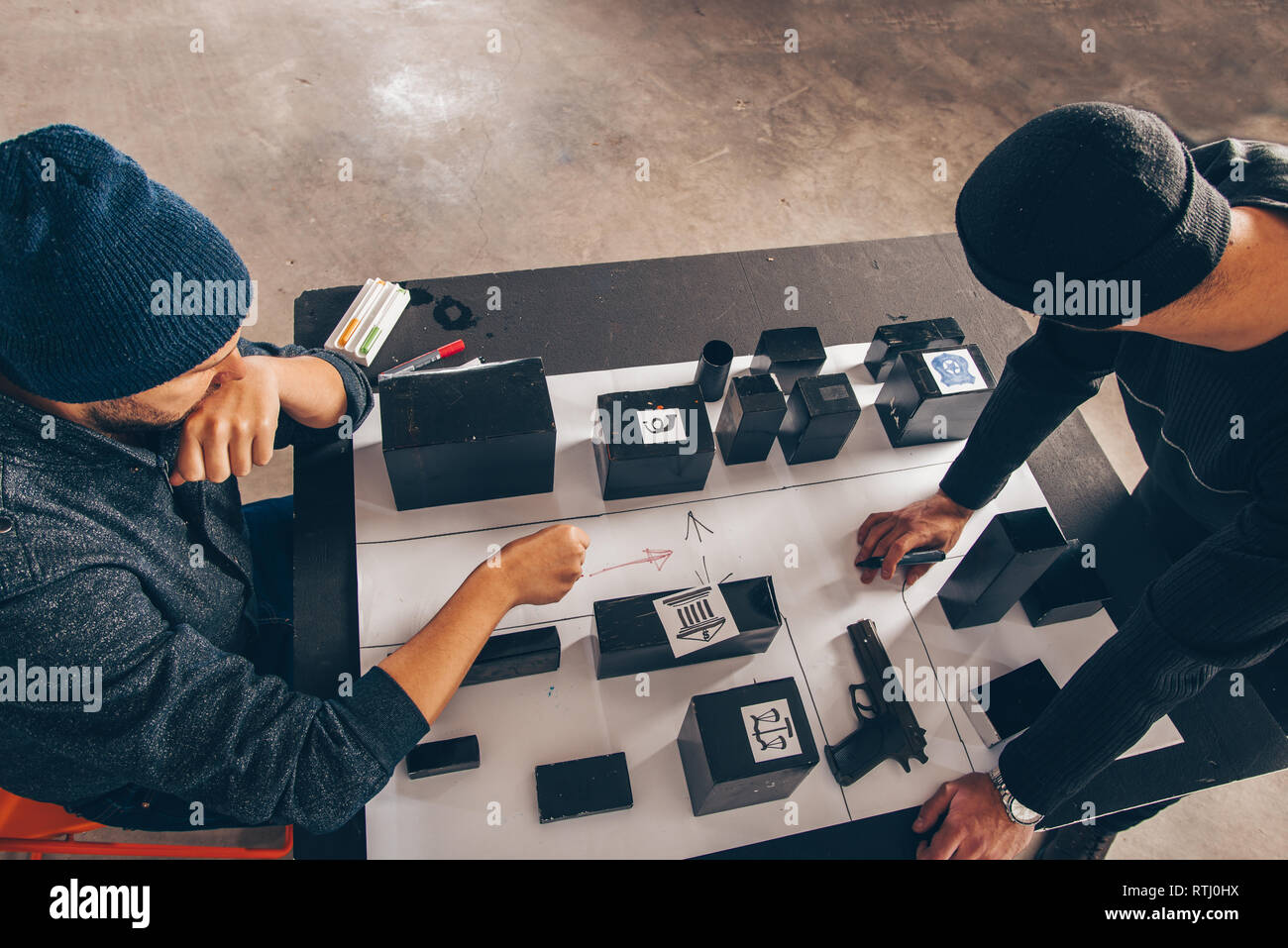 Two men sitting in a room and planning a robbery Stock Photo - Alamy