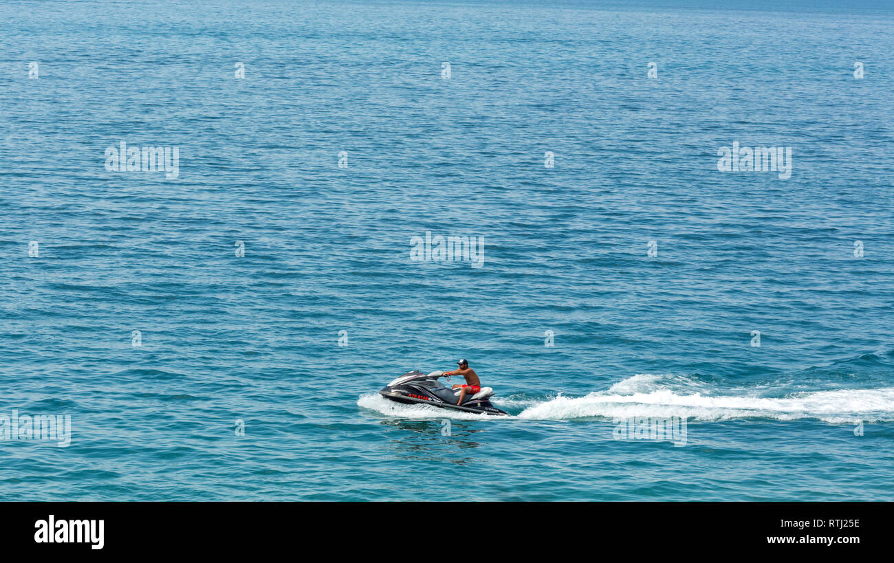Man riding jet ski on sea water background Stock Photo - Alamy