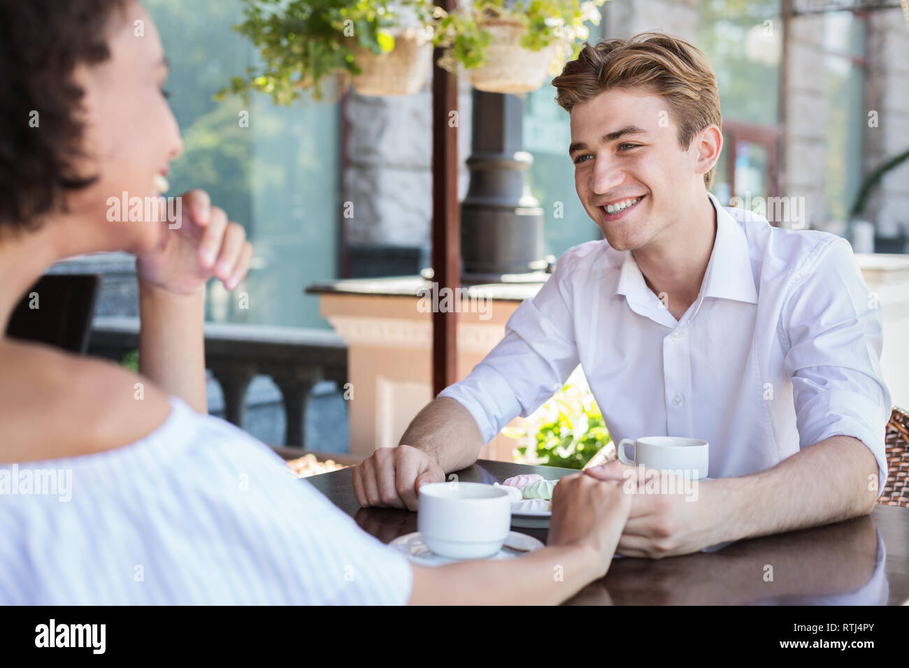 Happy interracial couple flirting at summer terrace Stock Photo - Alamy