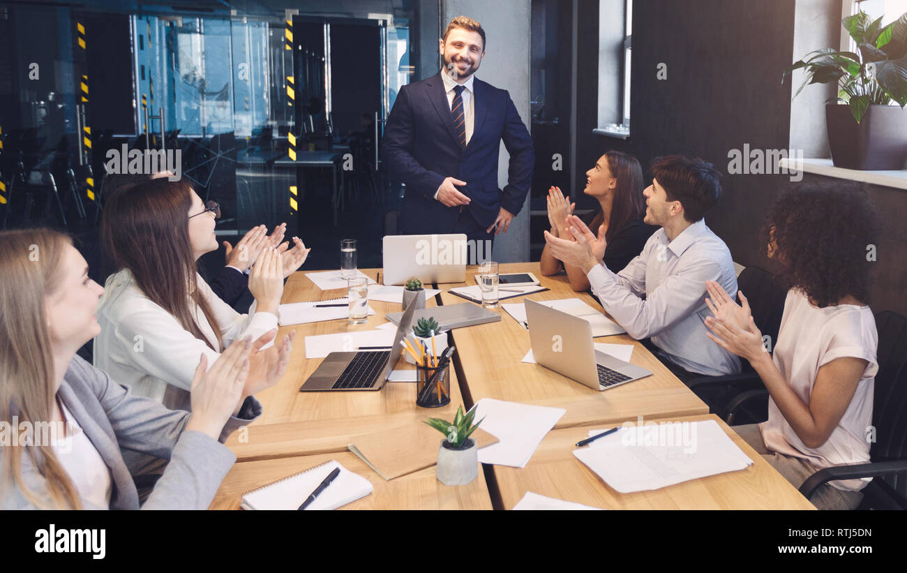 Business team congratulating successful leader with applause Stock ...