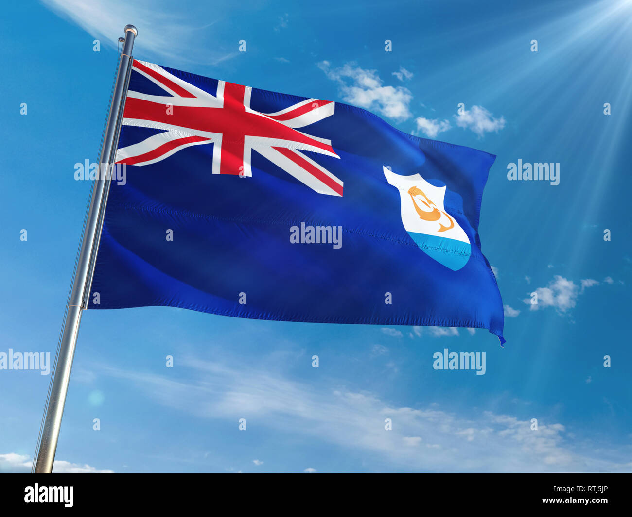 Anguilla National Flag Waving on pole against sunny blue sky background ...