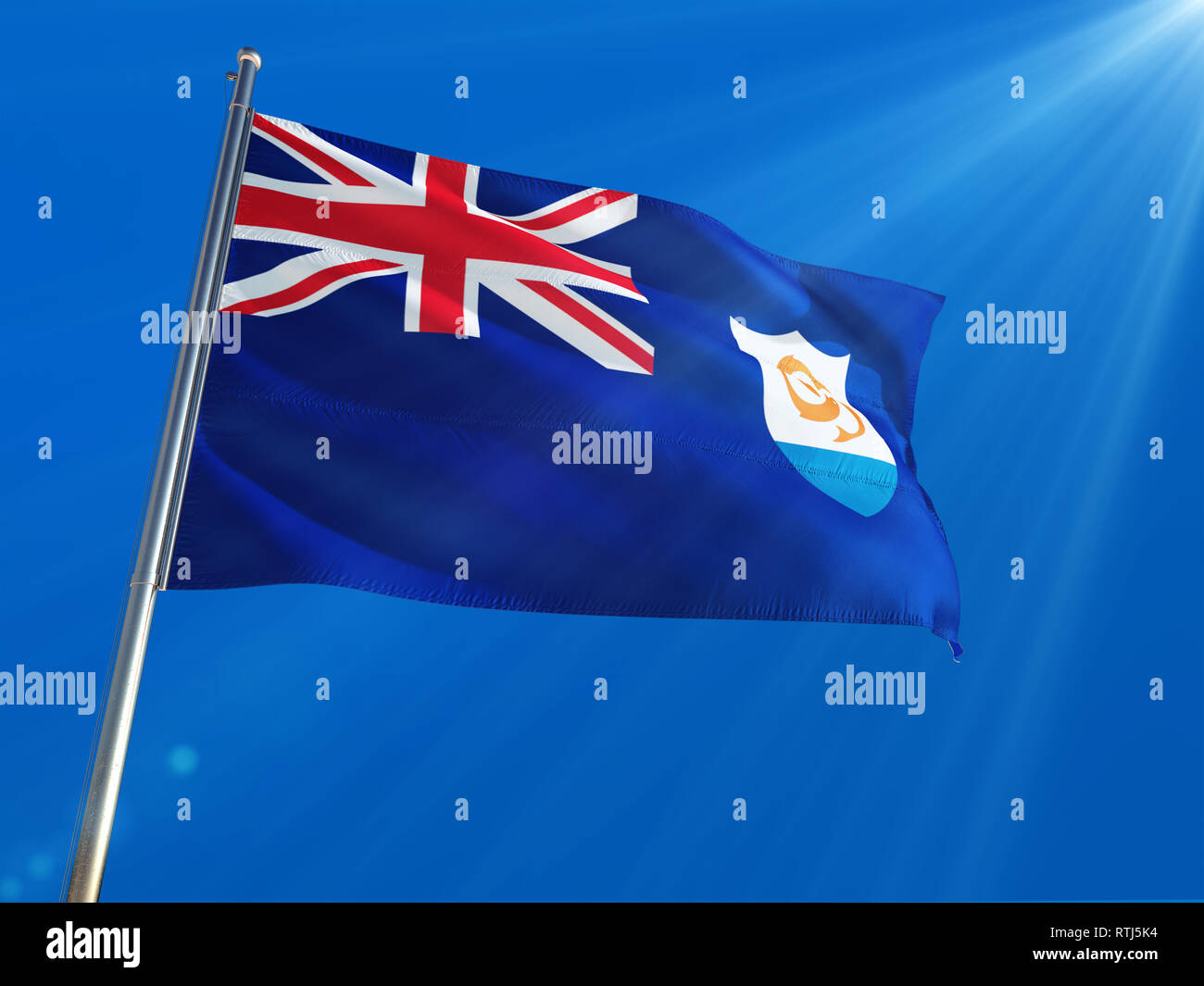Anguilla National Flag Waving on pole against deep blue sky background ...