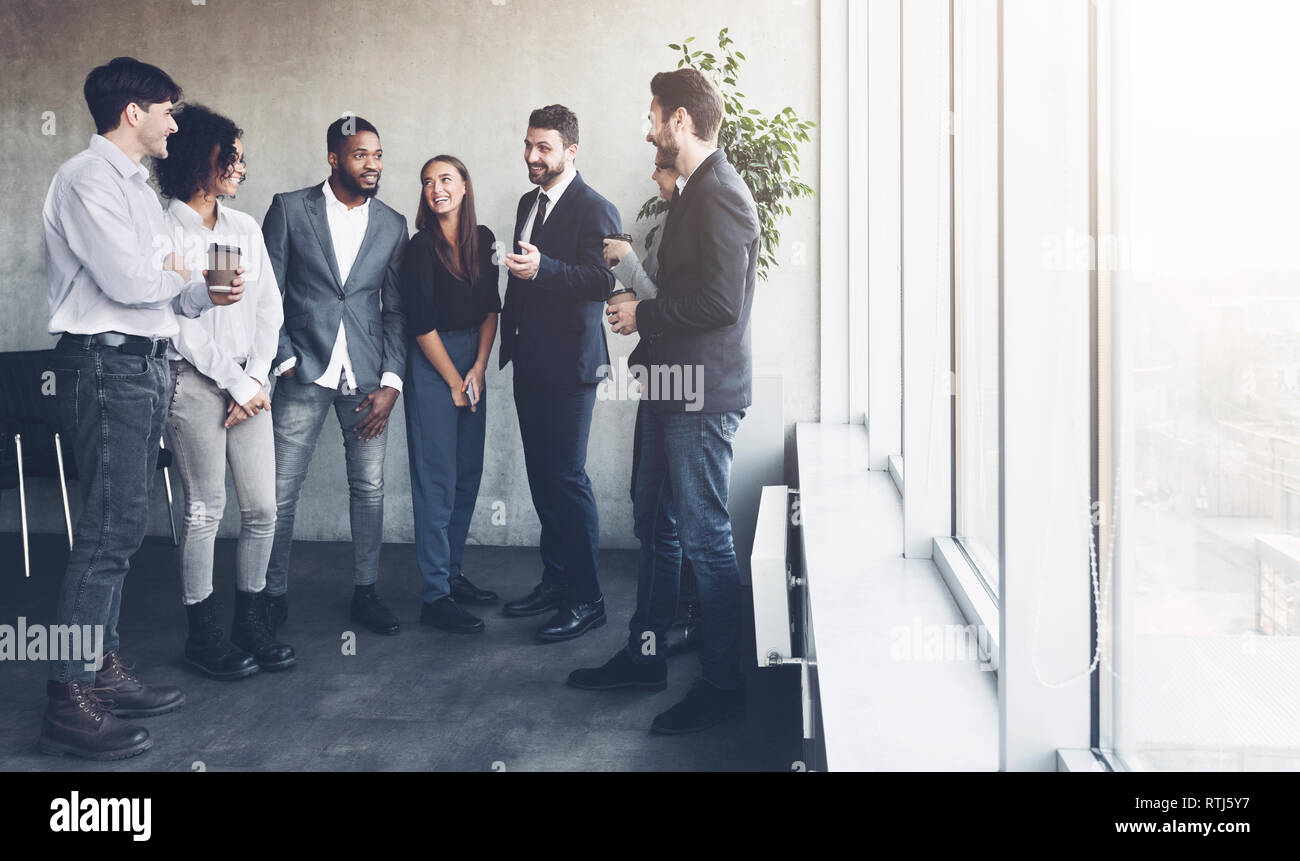 Business colleagues having coffee break near window Stock Photo - Alamy