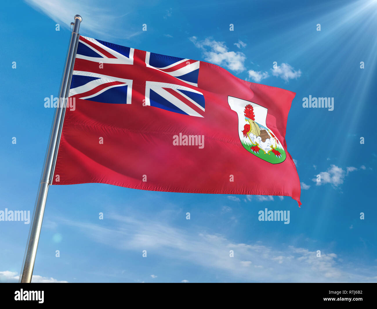 Bermuda National Flag Waving on pole against sunny blue sky background ...