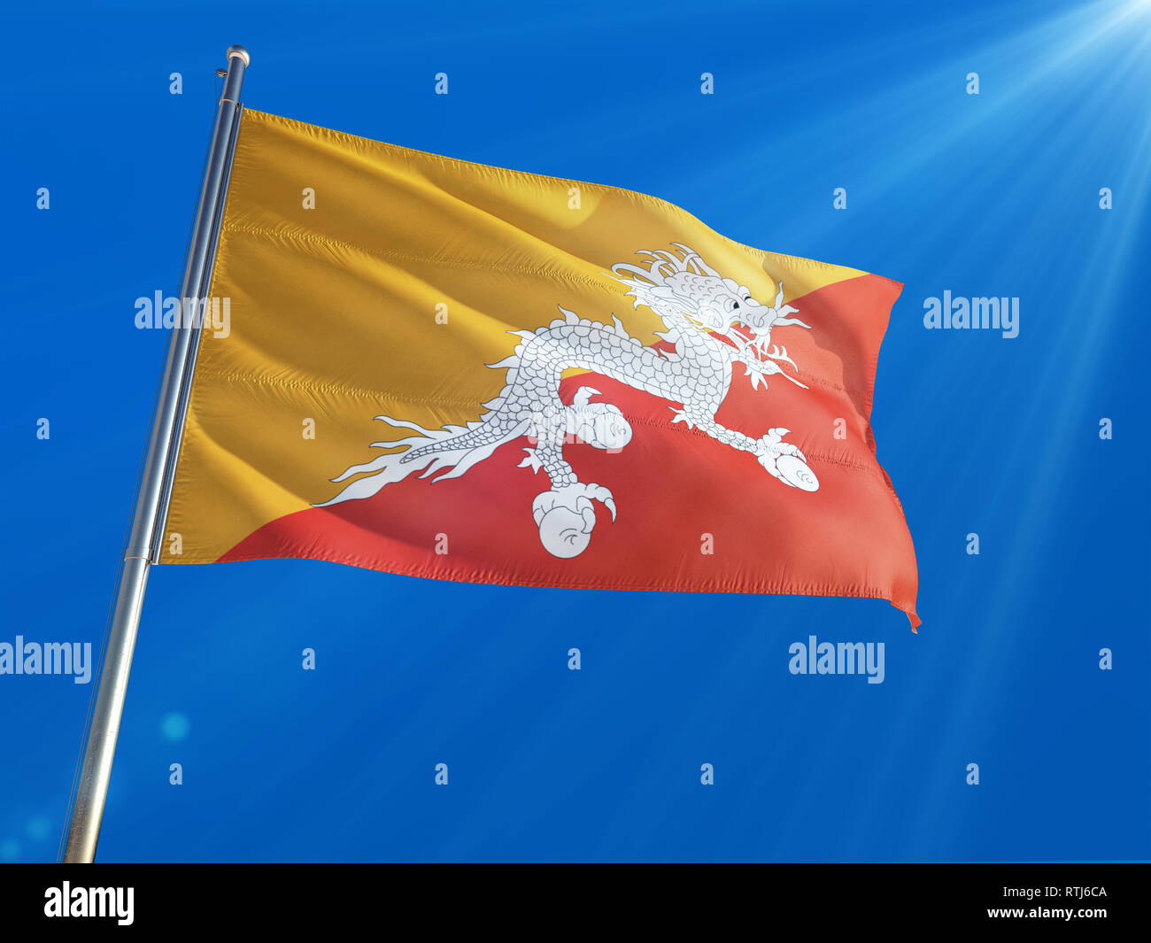 Bhutan National Flag Waving on pole against deep blue sky background ...