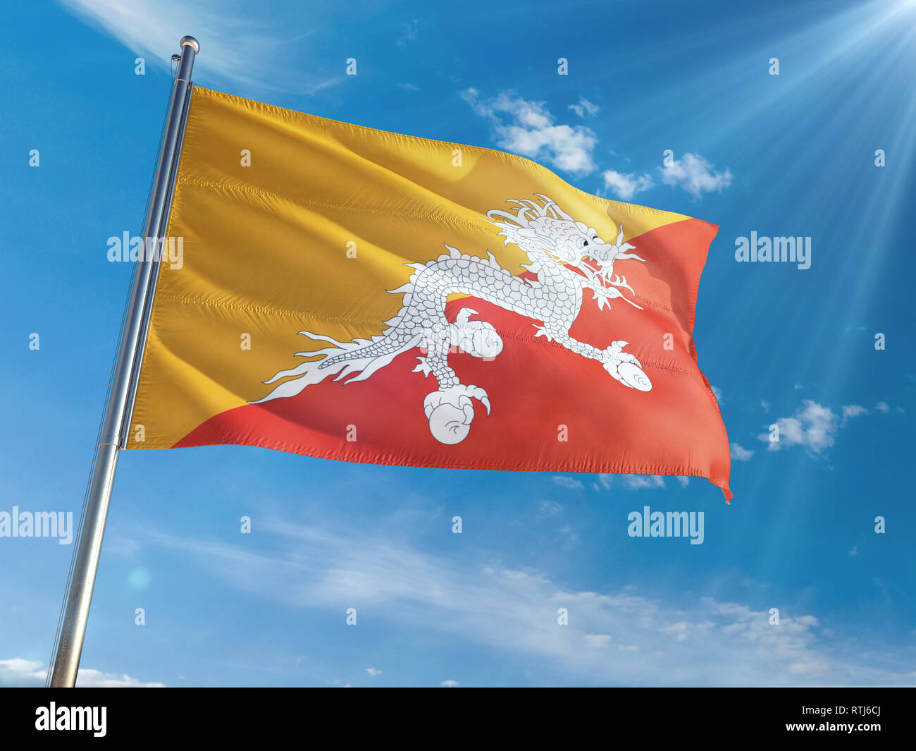 Bhutan National Flag Waving on pole against sunny blue sky background ...