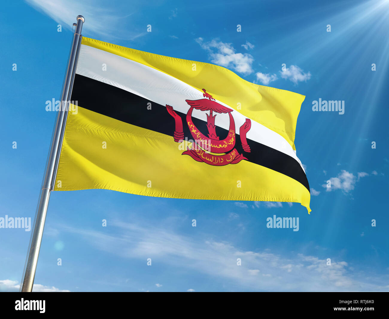 Brunei National Flag Waving on pole against sunny blue sky background ...