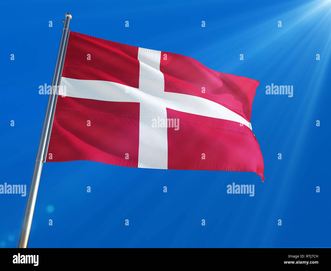 Denmark National Flag Waving on pole against deep blue sky background ...