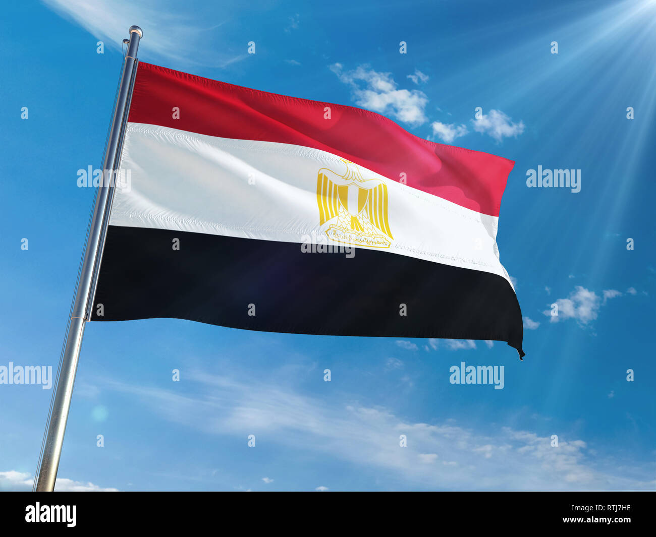 Egypt National Flag Waving on pole against sunny blue sky background ...