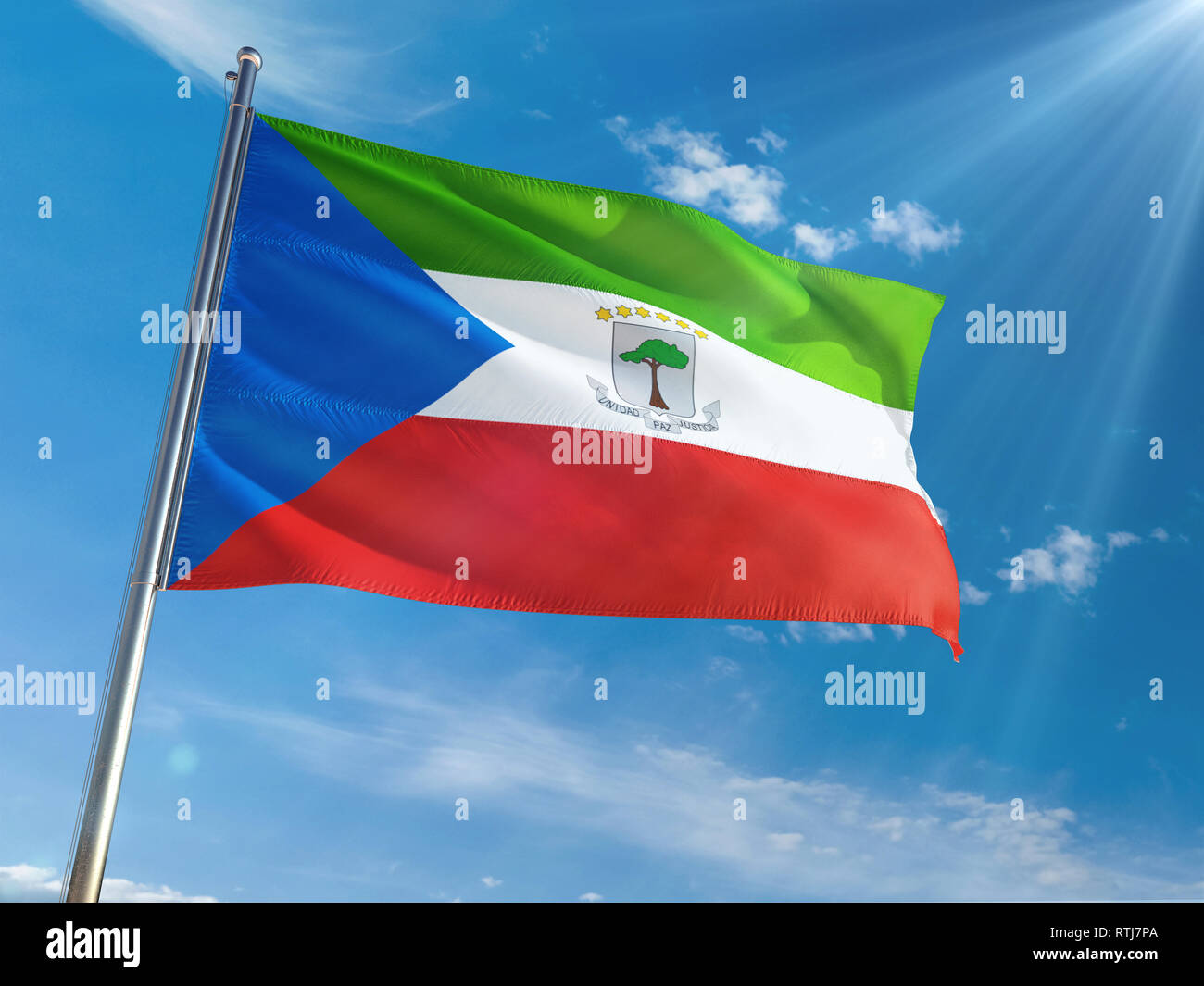 Equatorial Guinea National Flag Waving on pole against sunny blue sky ...