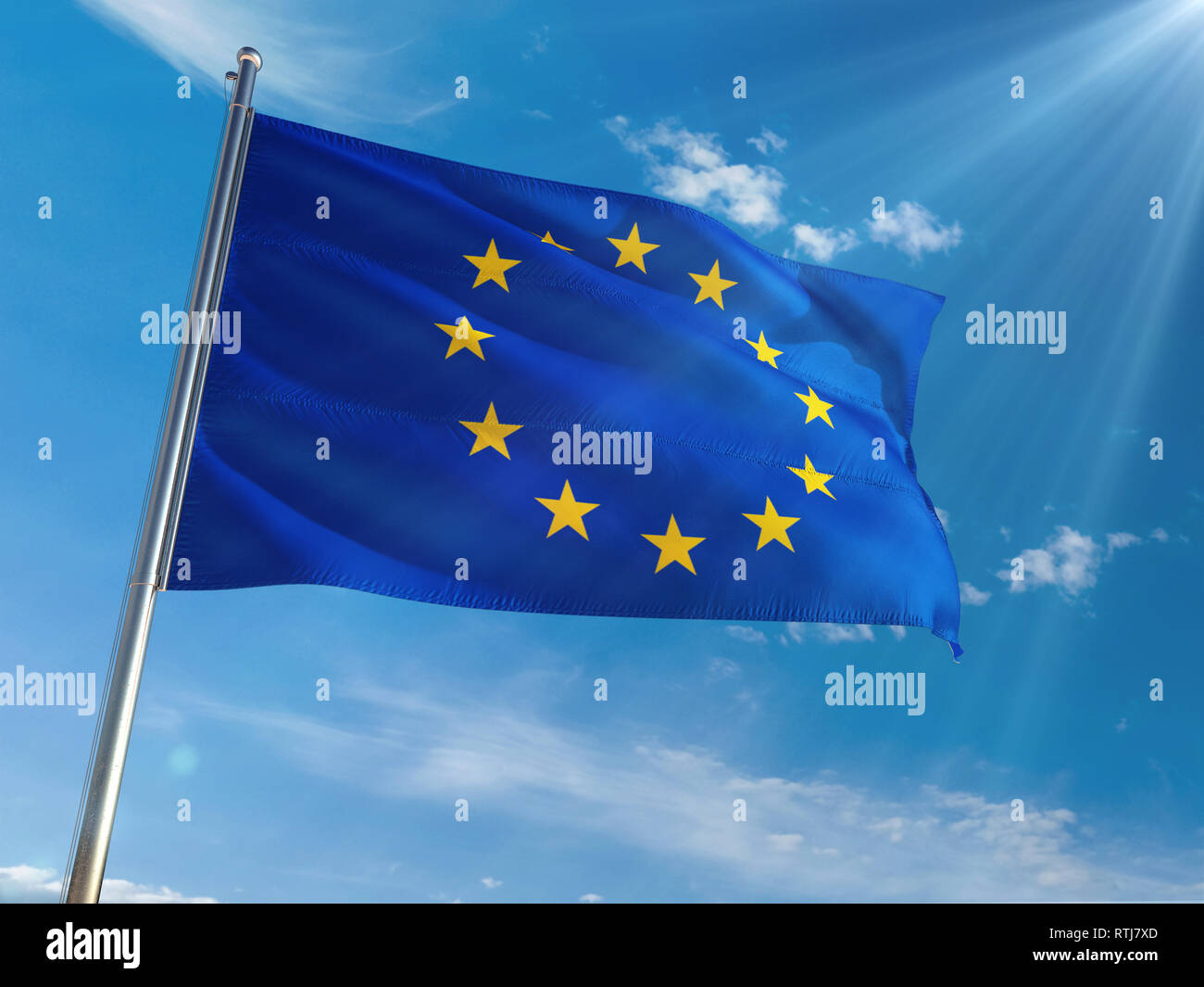 European Union National Flag Waving on pole against sunny blue sky ...