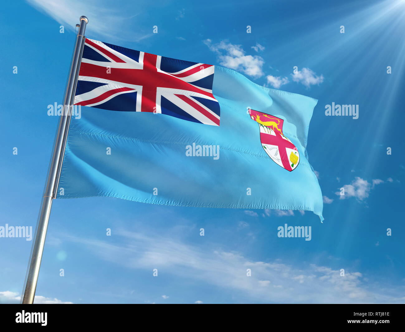 Fiji National Flag Waving on pole against sunny blue sky background ...
