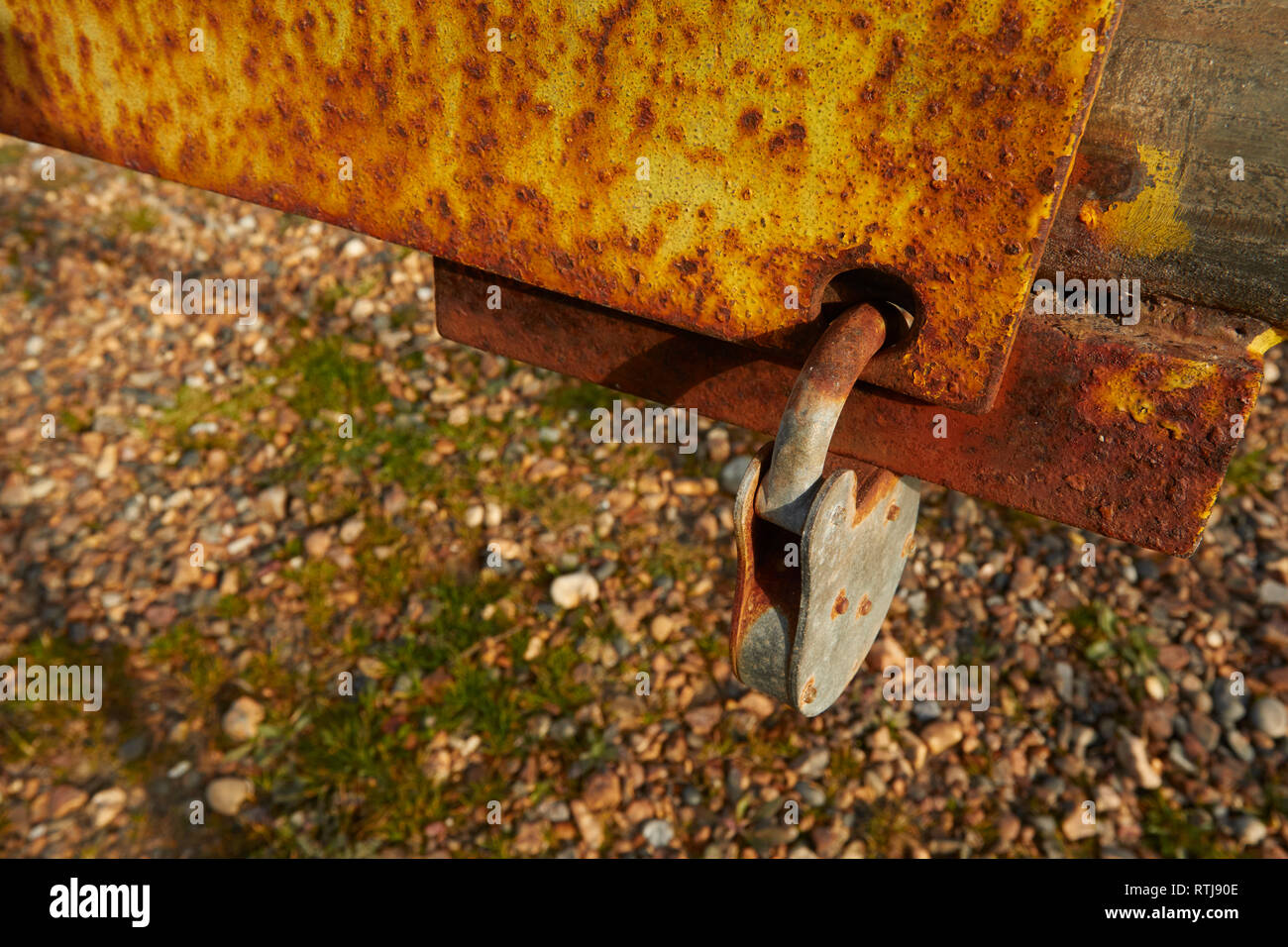 Yellow rusty bar and padlock still-life Stock Photo - Alamy