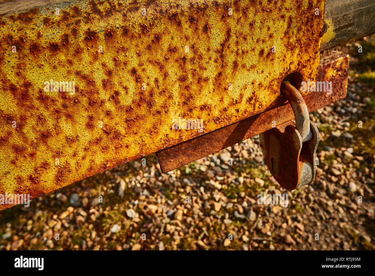 Yellow rusty bar and padlock still-life Stock Photo - Alamy