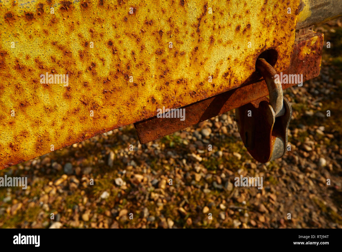 Yellow rusty bar and padlock still-life Stock Photo - Alamy