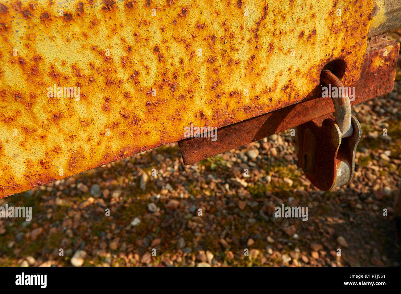 Yellow rusty bar and padlock still-life Stock Photo - Alamy